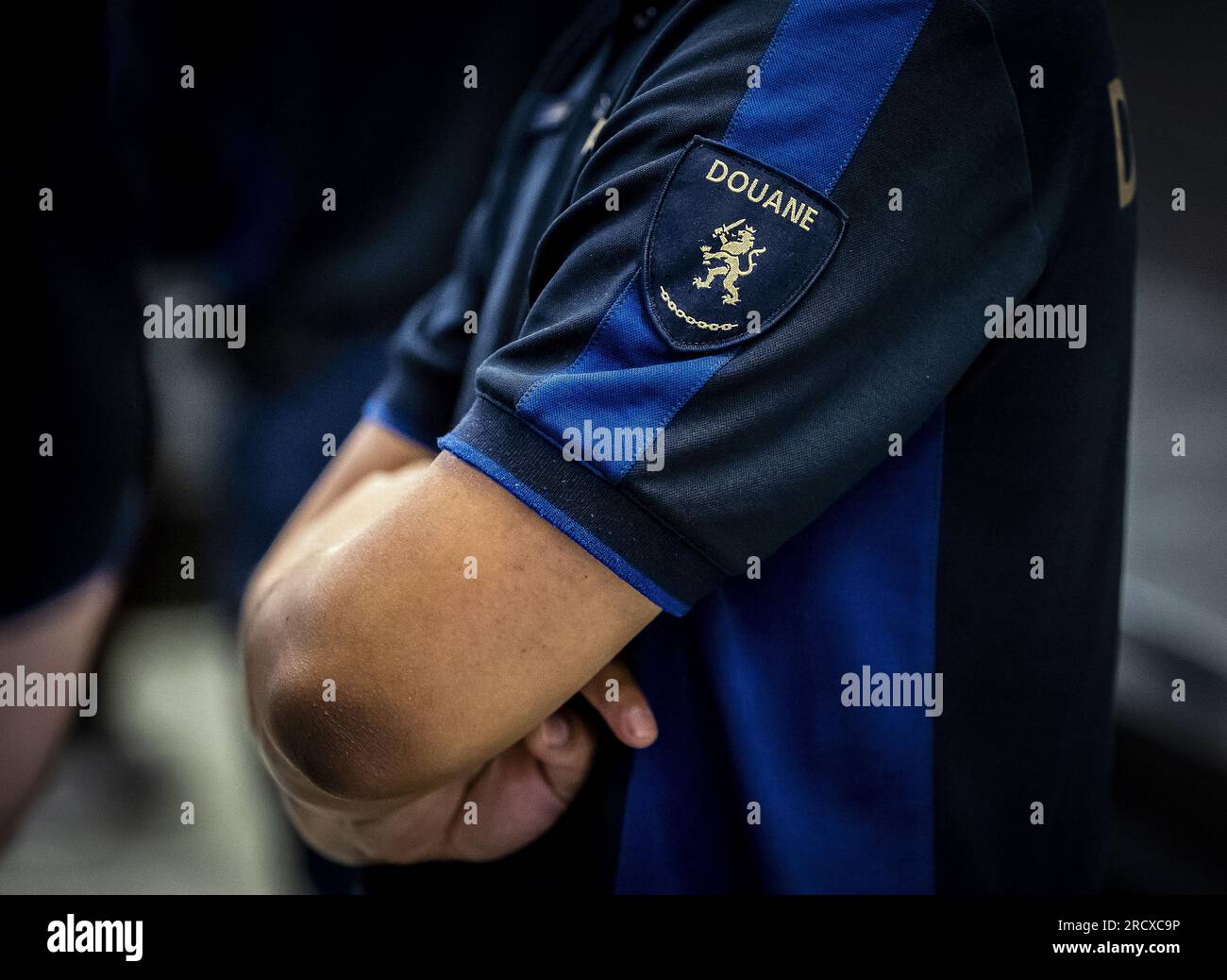 SCHIPHOL - A customs officer in the arrivals hall at Schiphol Airport ...