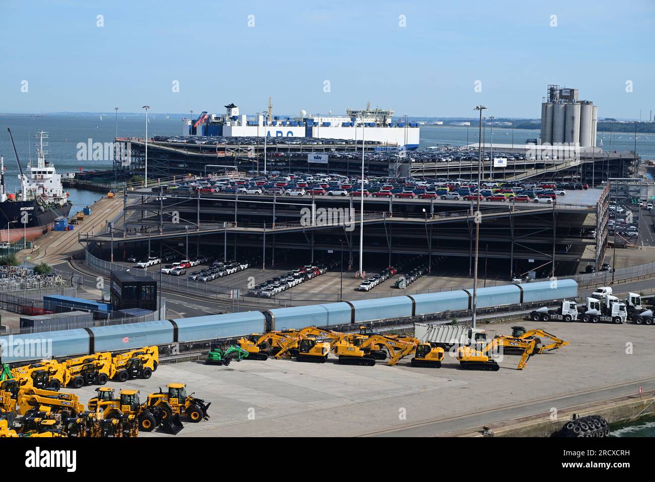 A car carrier train and yellow JCB's on the quayside at Southampton ...