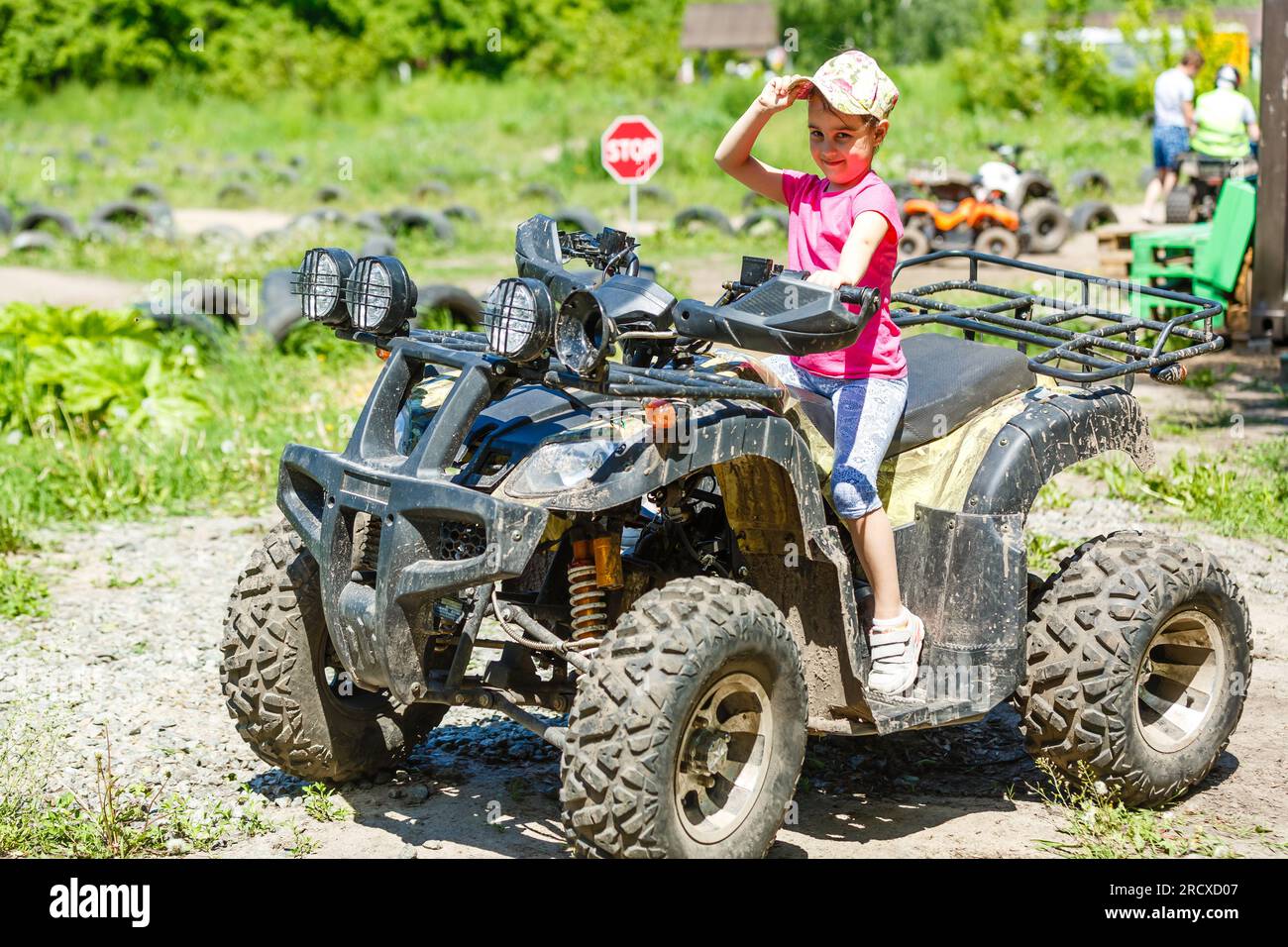 A child rides a quad bike through the mud. ATV rider rides Stock Photo ...