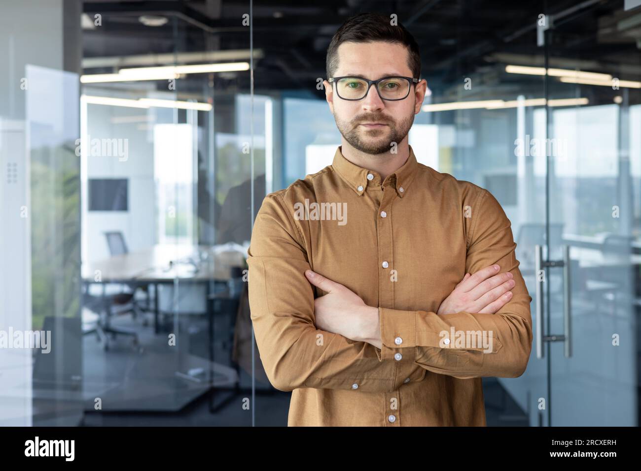 Portrait of a young self-confident businessman, executive director ...