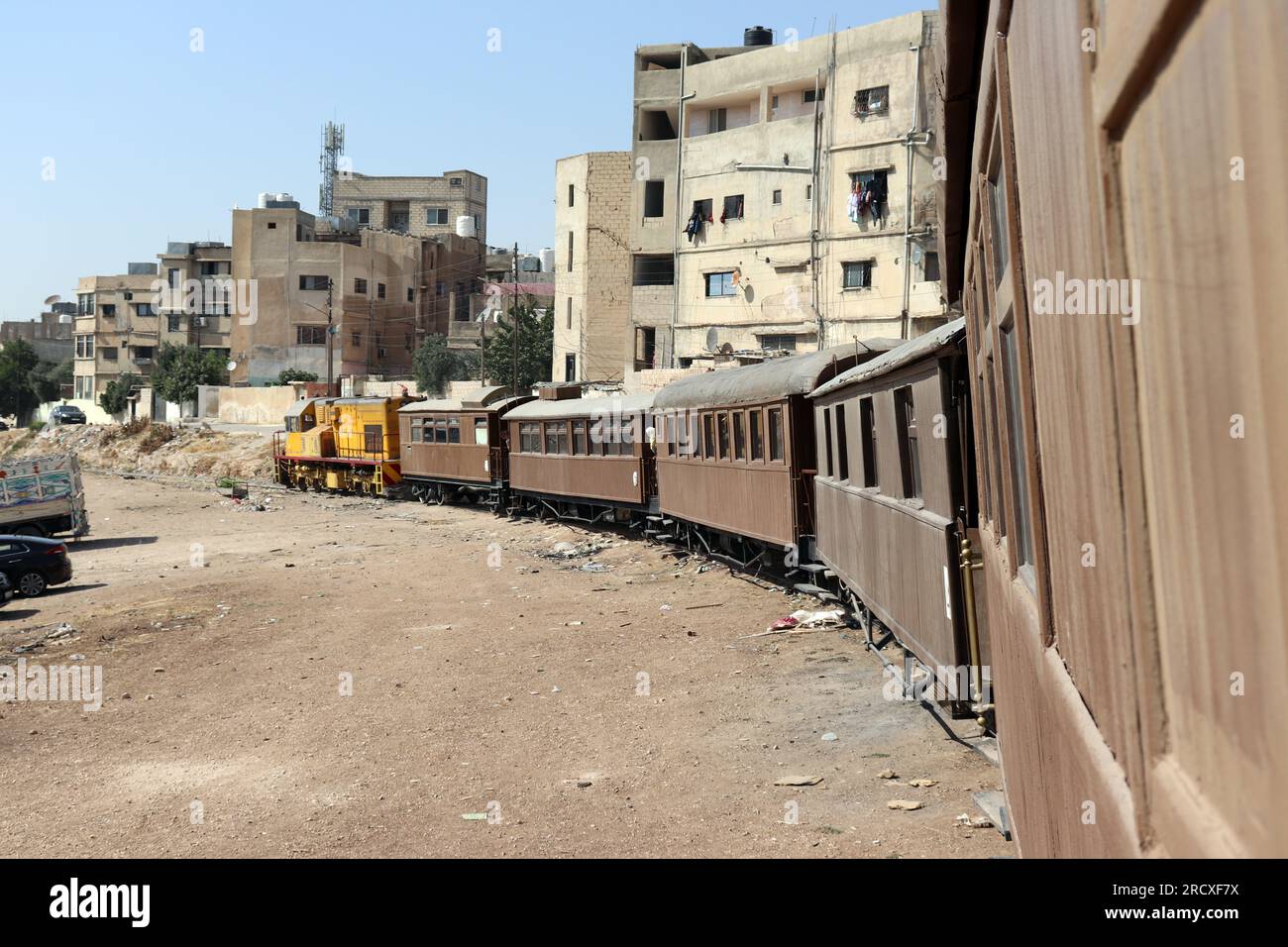 A train among houses - An old Turkish Ottoman steam train in Jordan ...