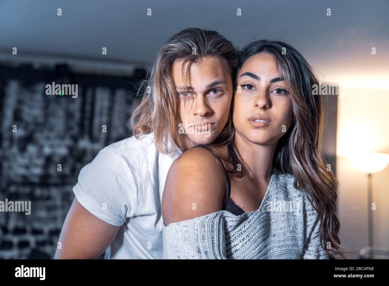 Inside house couple shooting dancing in living room in serious way ...