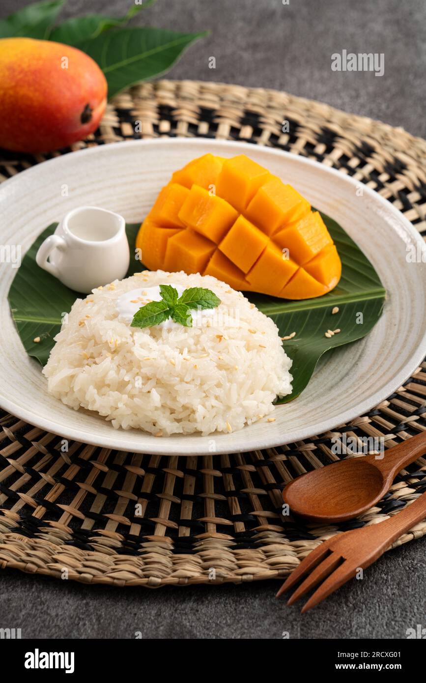 Delicious Thai mango sticky rice with cut fresh mango fruit in a plate ...