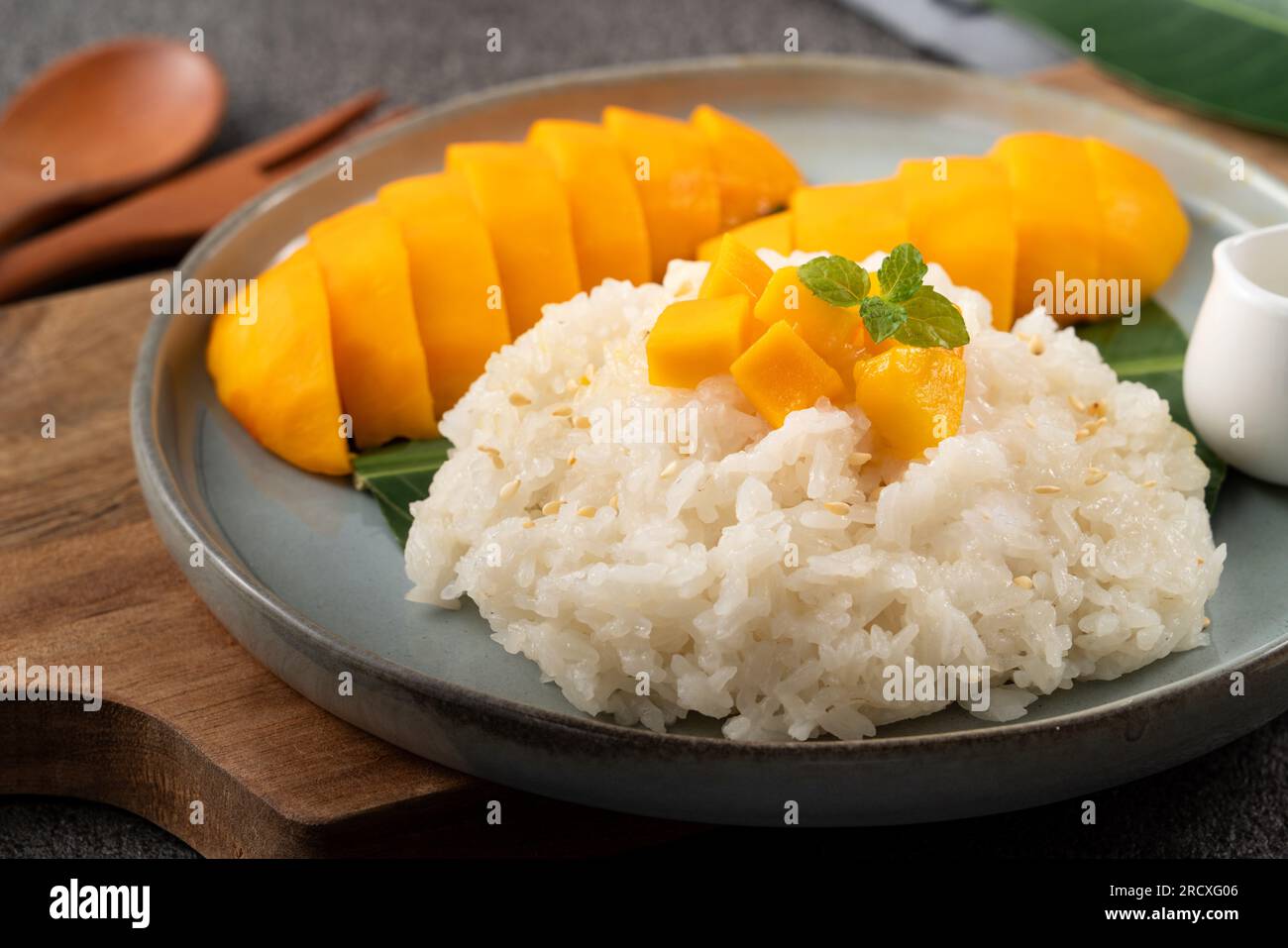 Delicious Thai mango sticky rice with cut fresh mango fruit in a plate ...