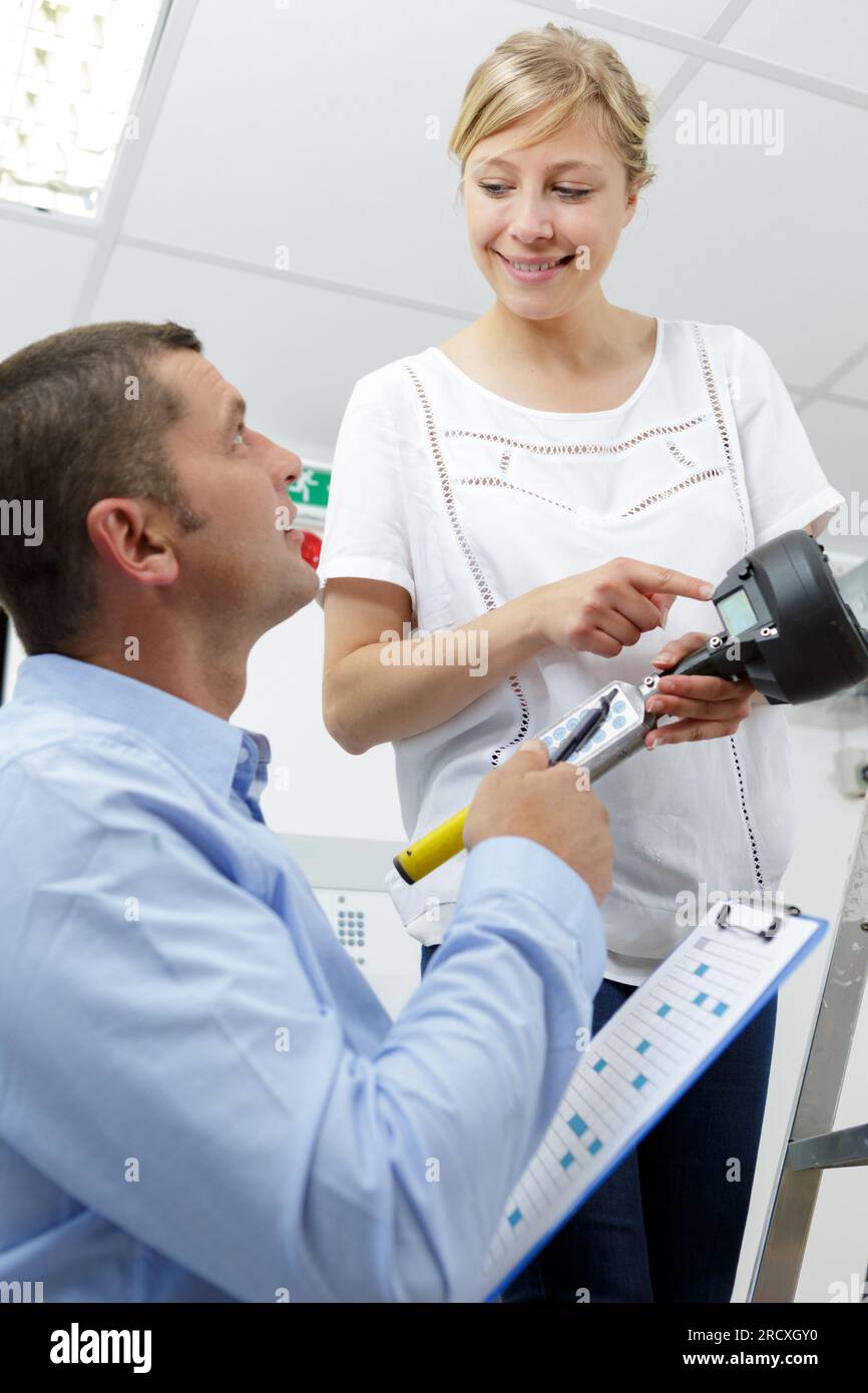 workers checking the oxygen levels in office Stock Photo - Alamy