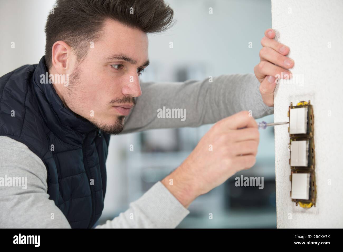 installation of the light switch Stock Photo - Alamy