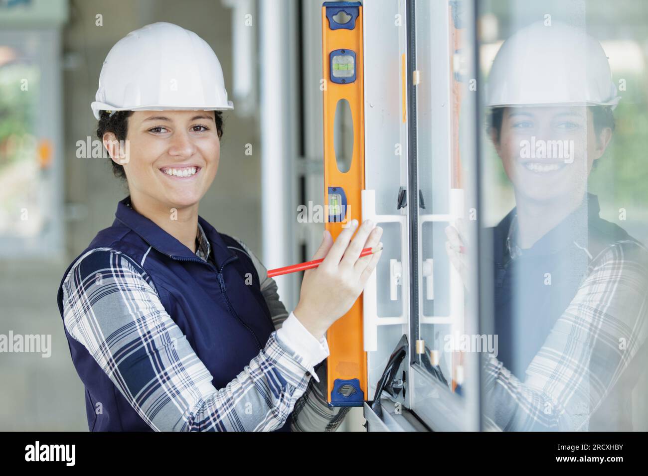 happy woman using spirit level Stock Photo - Alamy