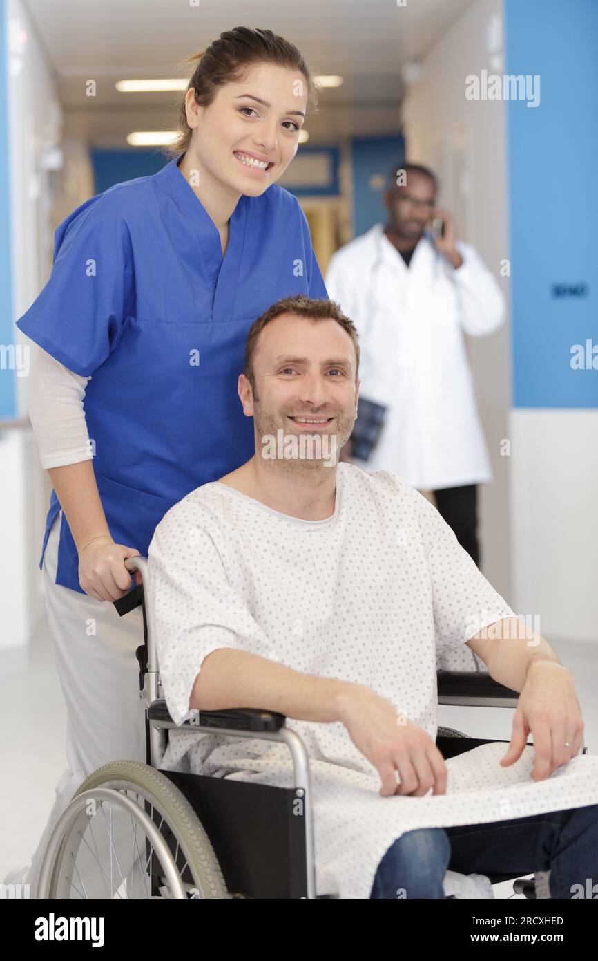 nurse pushing patient in a wheelchair Stock Photo - Alamy