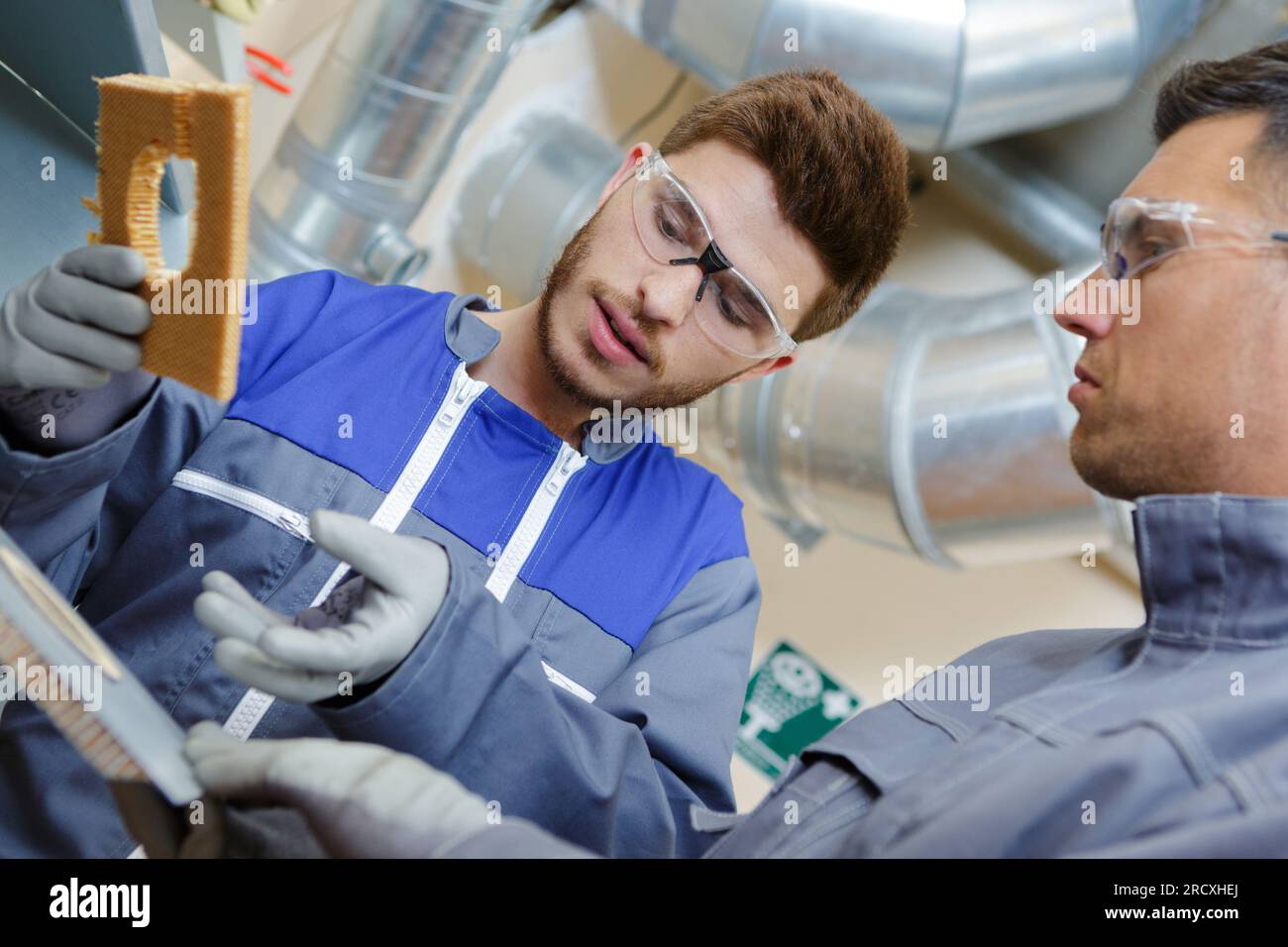 mechanic and apprentice working on car together Stock Photo - Alamy