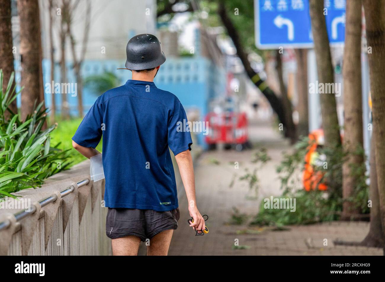 Hong Kong, China. 17th July, 2023. A man with a metal helmet as he ...