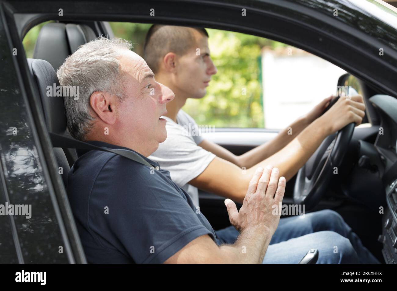 2 men are driving a car Stock Photo - Alamy