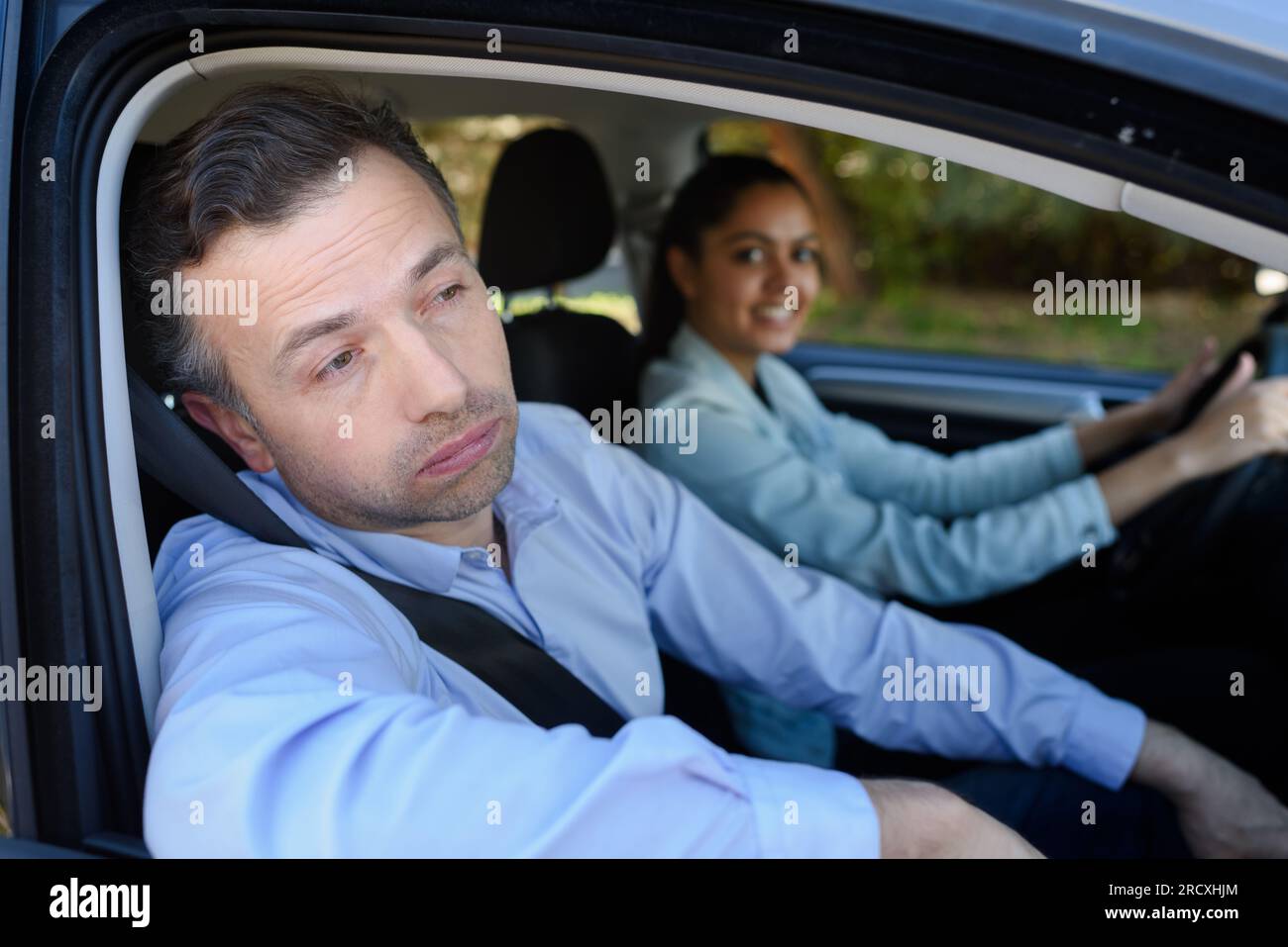bored instructor teaching woman to drive Stock Photo - Alamy