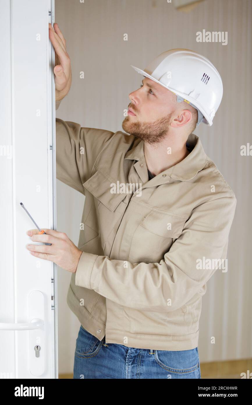 man working with window frame Stock Photo - Alamy