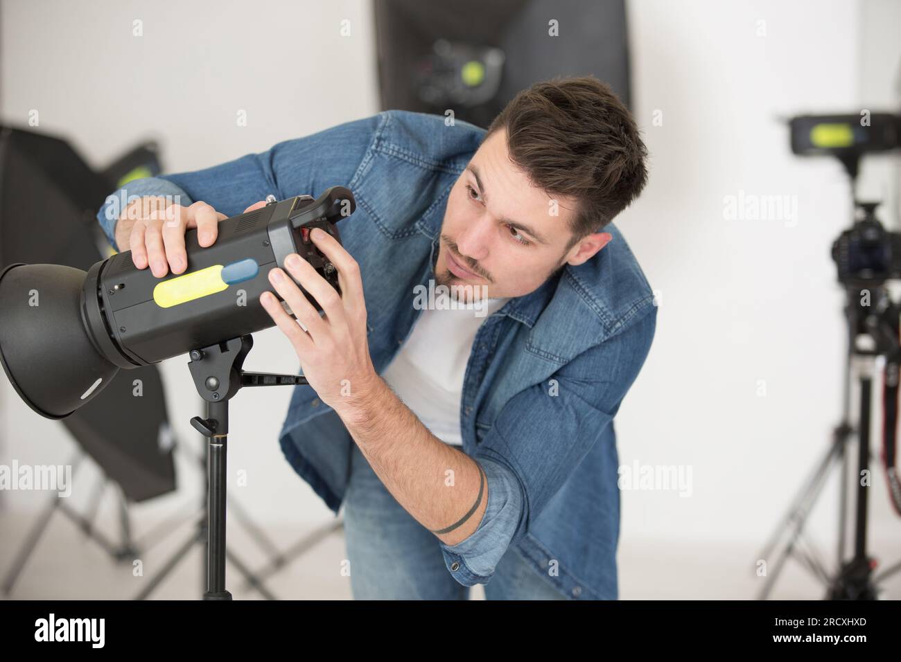 a man fixing the lighting equipment Stock Photo - Alamy