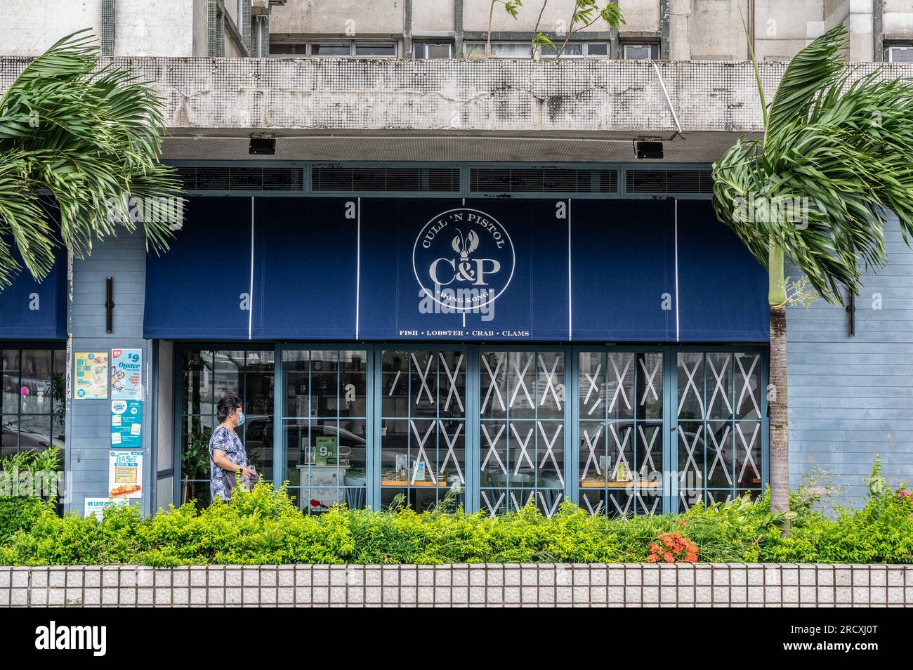 A restaurant tapes up its windows as protection against breakage during ...