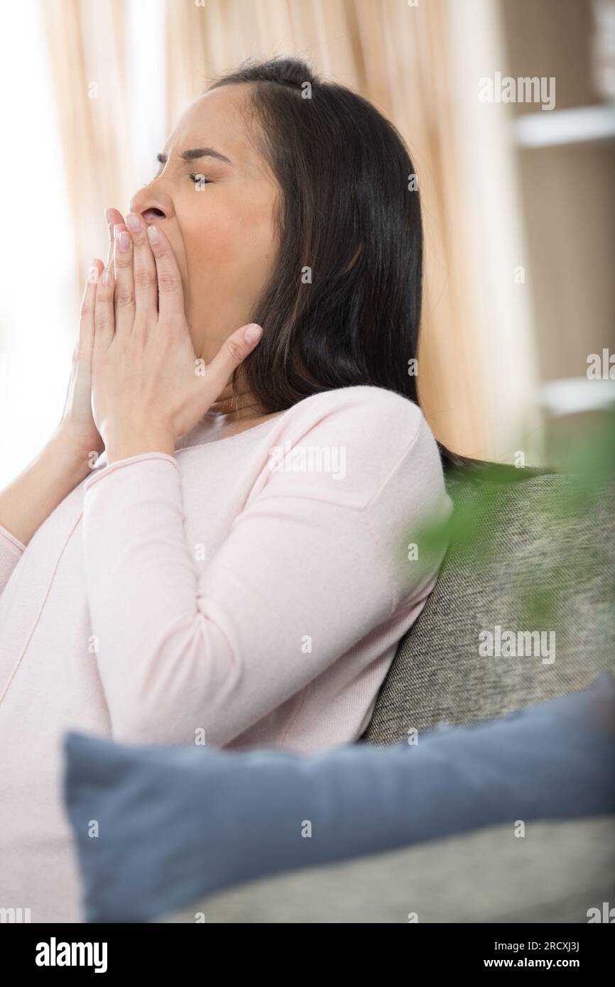 tired woman yawning Stock Photo - Alamy
