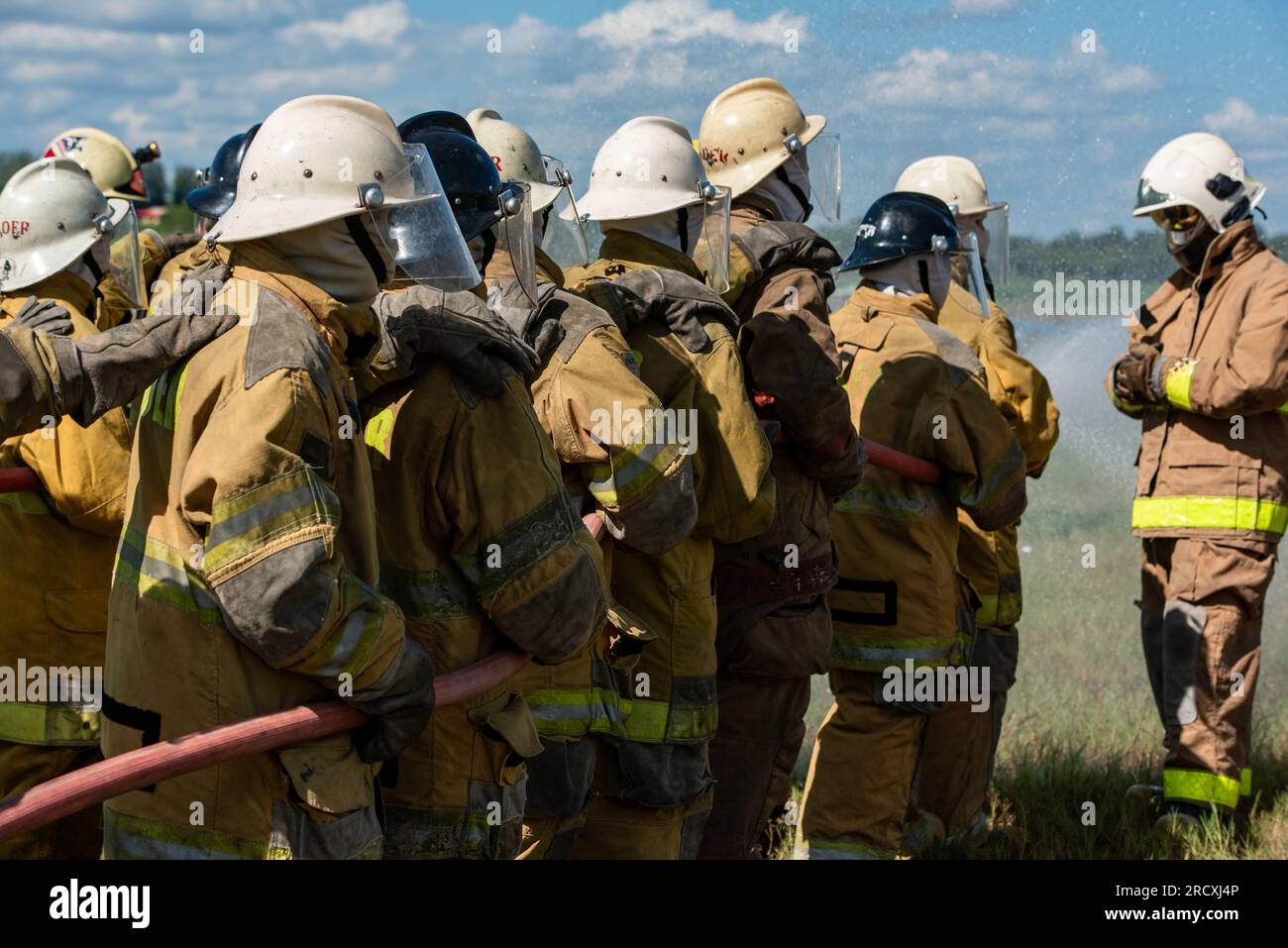 Firefighters and rescue training. Firefighter spraying high pressure ...