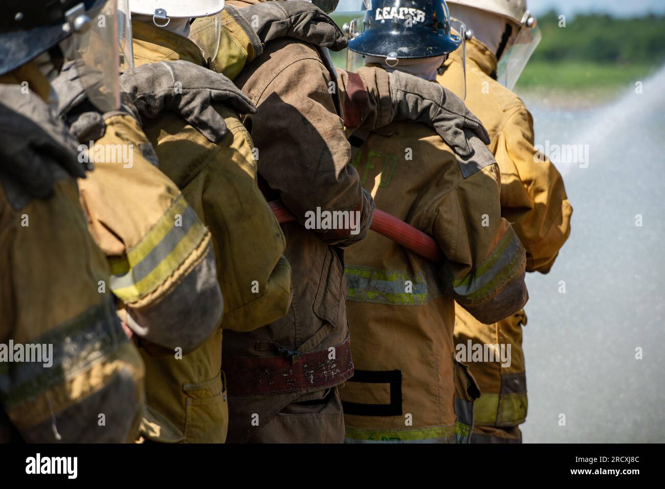 Firefighters and rescue training. Firefighter spraying high pressure ...