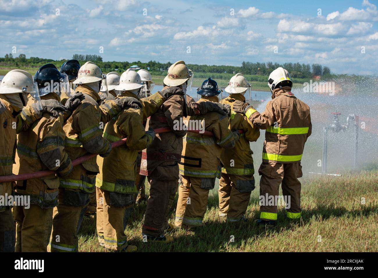Firefighters and rescue training. Firefighter spraying high pressure ...