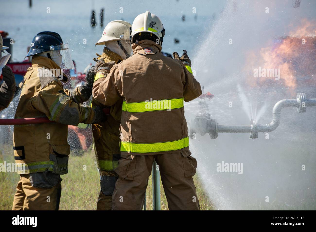 Firefighters and rescue training. Firefighter spraying high pressure ...