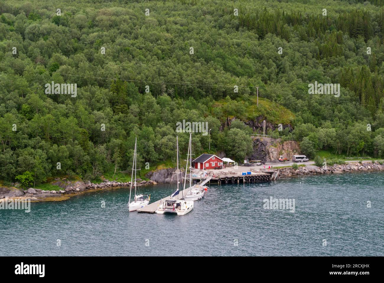 Three yachts moored at jetty of Svartigen Marina end of Holandsfjord ...