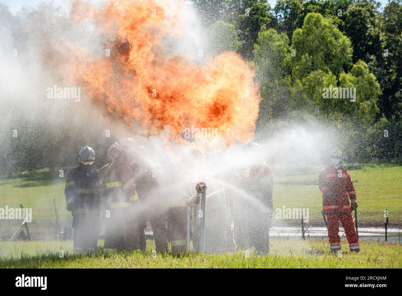 Firefighters and rescue training. Firefighter spraying high pressure ...