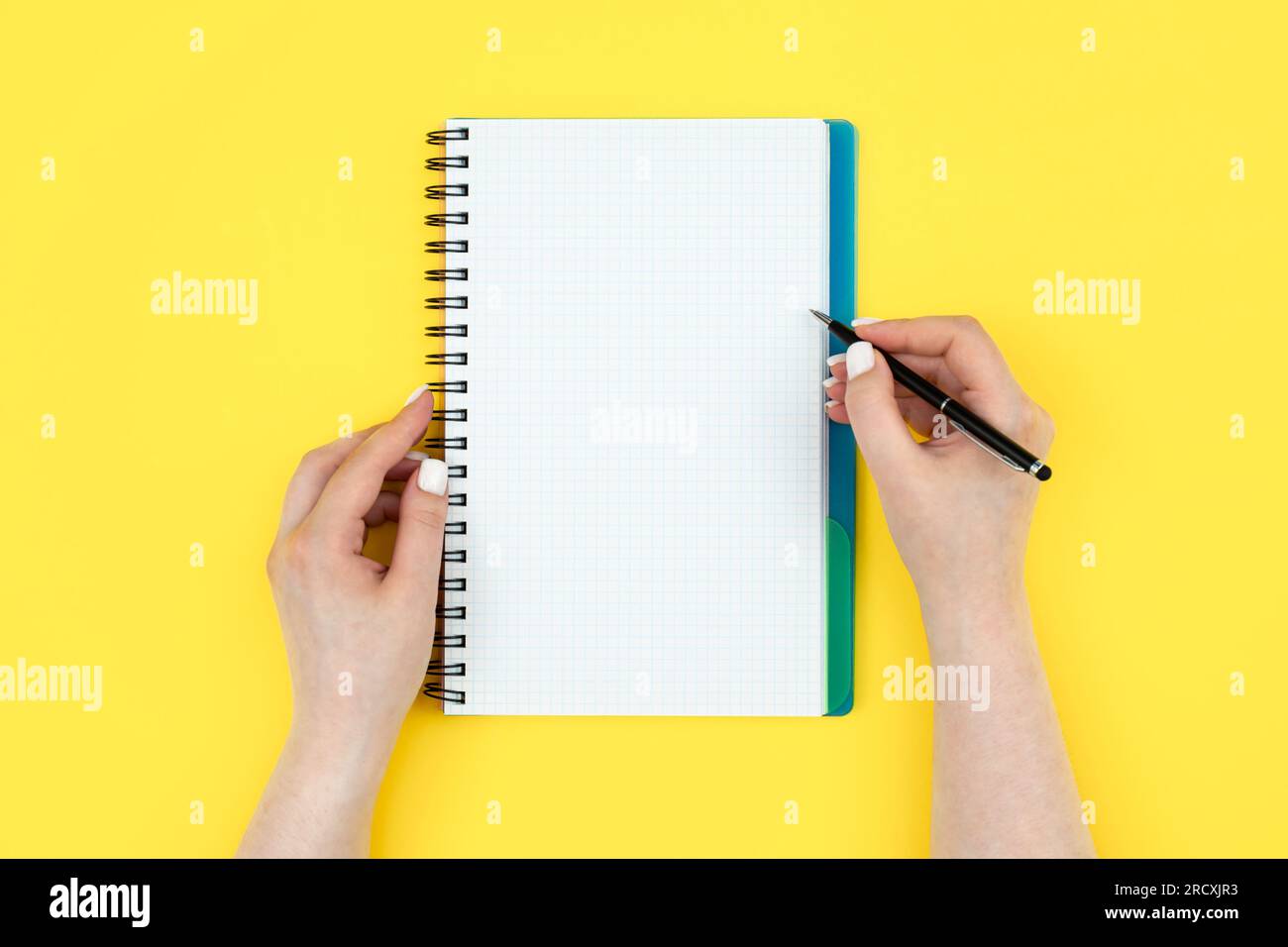 Female hands writing in notepad on yellow background, flat lay Stock Photo - Alamy