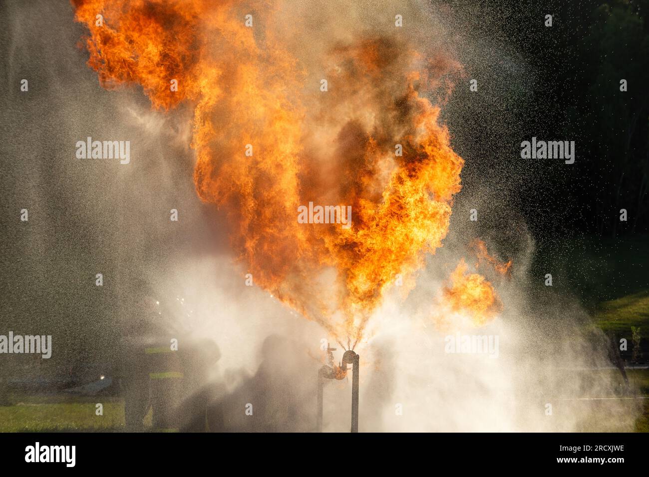 Firefighters and rescue training. Firefighter spraying high pressure ...