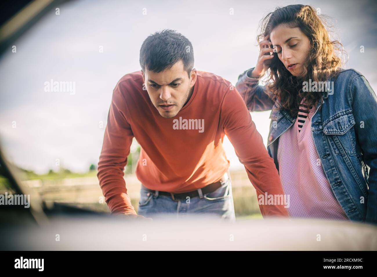 Breakdown car couple checking hi-res stock photography and images - Alamy