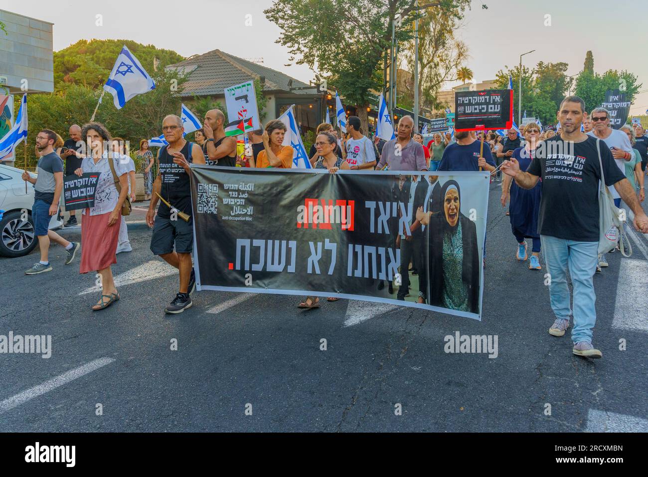 Haifa, Israel - July 15, 2023: People march with anti-occupation signs ...
