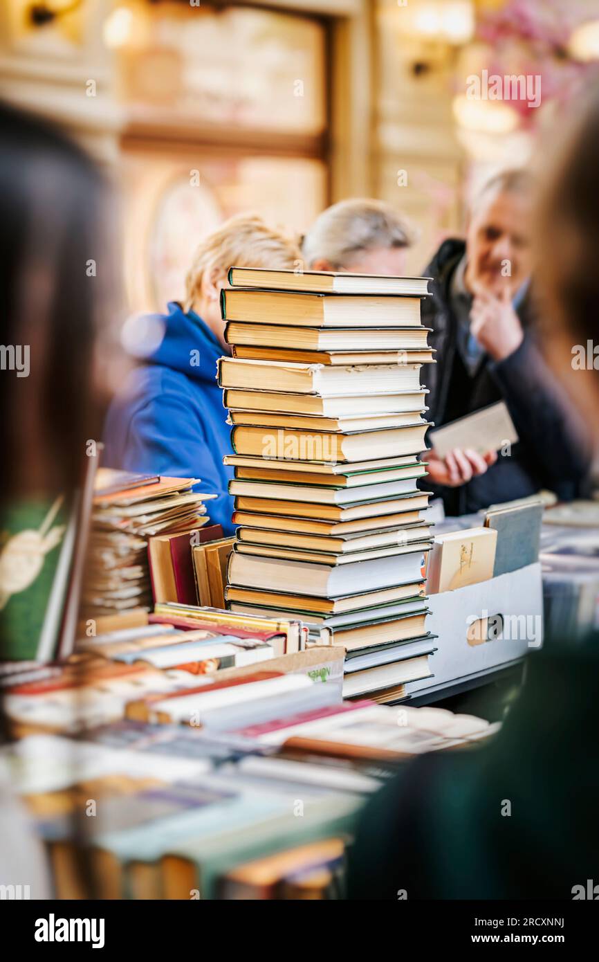 Pile of used Books on desk of bookshop Stock Photo - Alamy