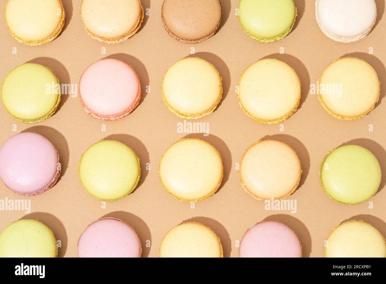 An assortment of macarons are neatly arranged in rows on a flat surface Stock Photo - Alamy