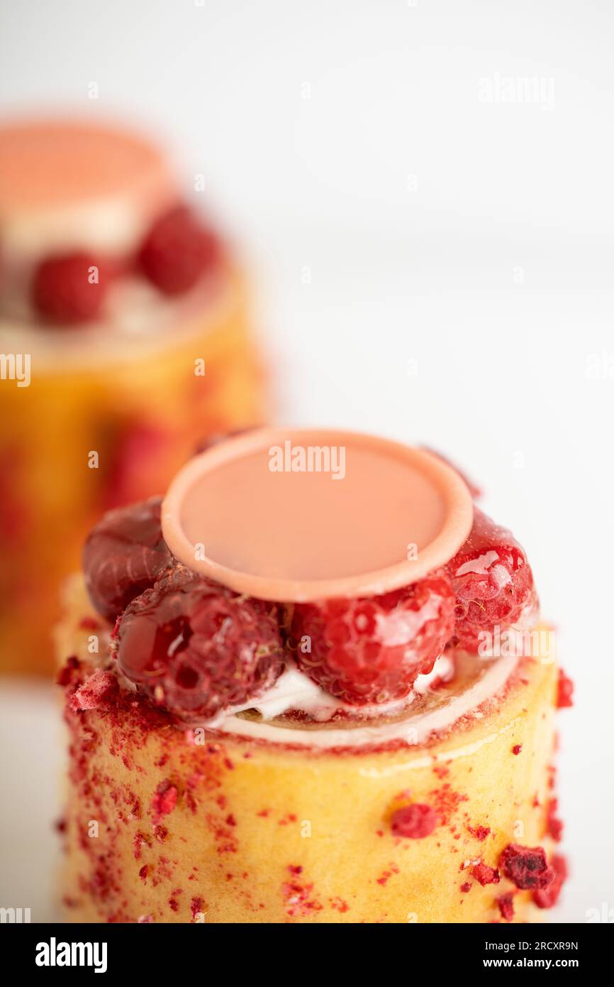 A delicious dessert of raspberry pudding topped with luscious cream and ...