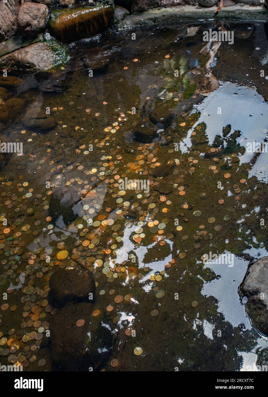 Wishing well with coins in a pond, sweden Stock Photo - Alamy