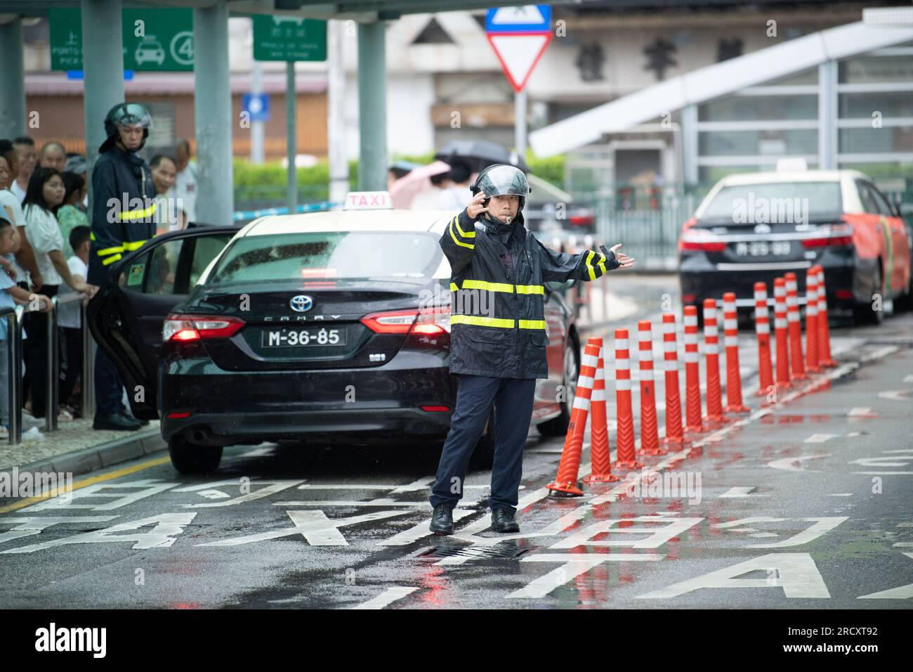 Macao, China. 17th July, 2023. Traffic police officers work in rain as ...