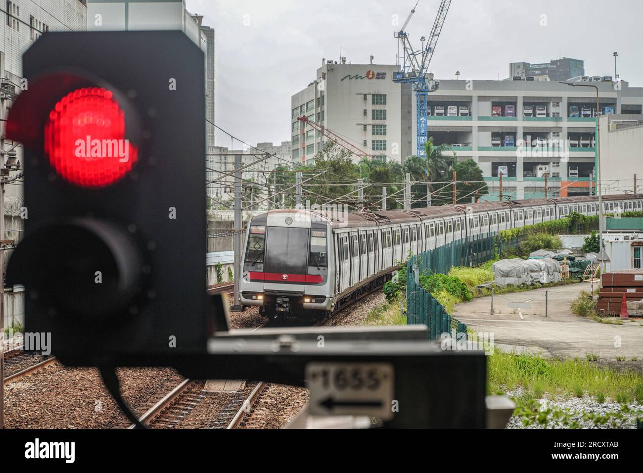 A MTR subway train is driven on the track during the No.8 Warning ...