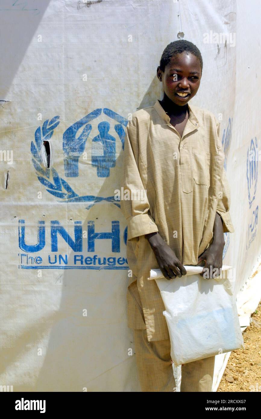 A young Sudanese refugee stands in front of their classroom tent at the ...