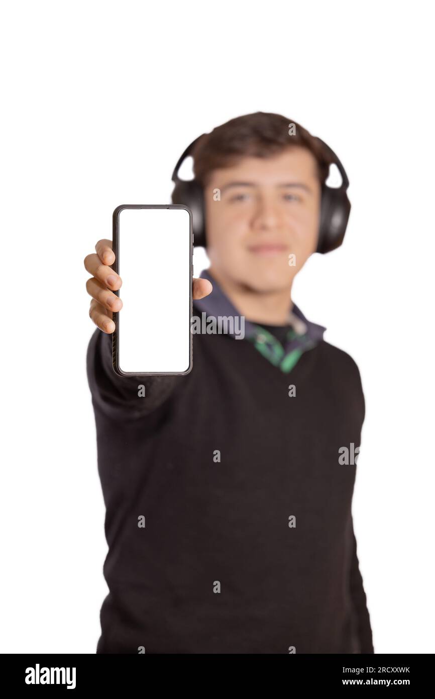 Caucasian boy with headphones out of focus shows the blank screen of ...