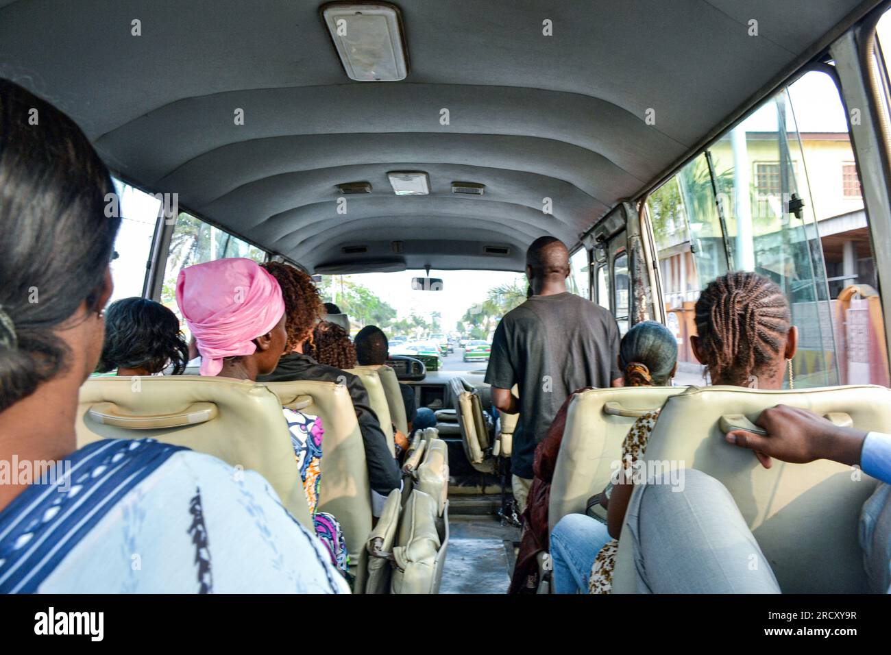 Passengers on a public transport bus on a street in Brazzaville ...