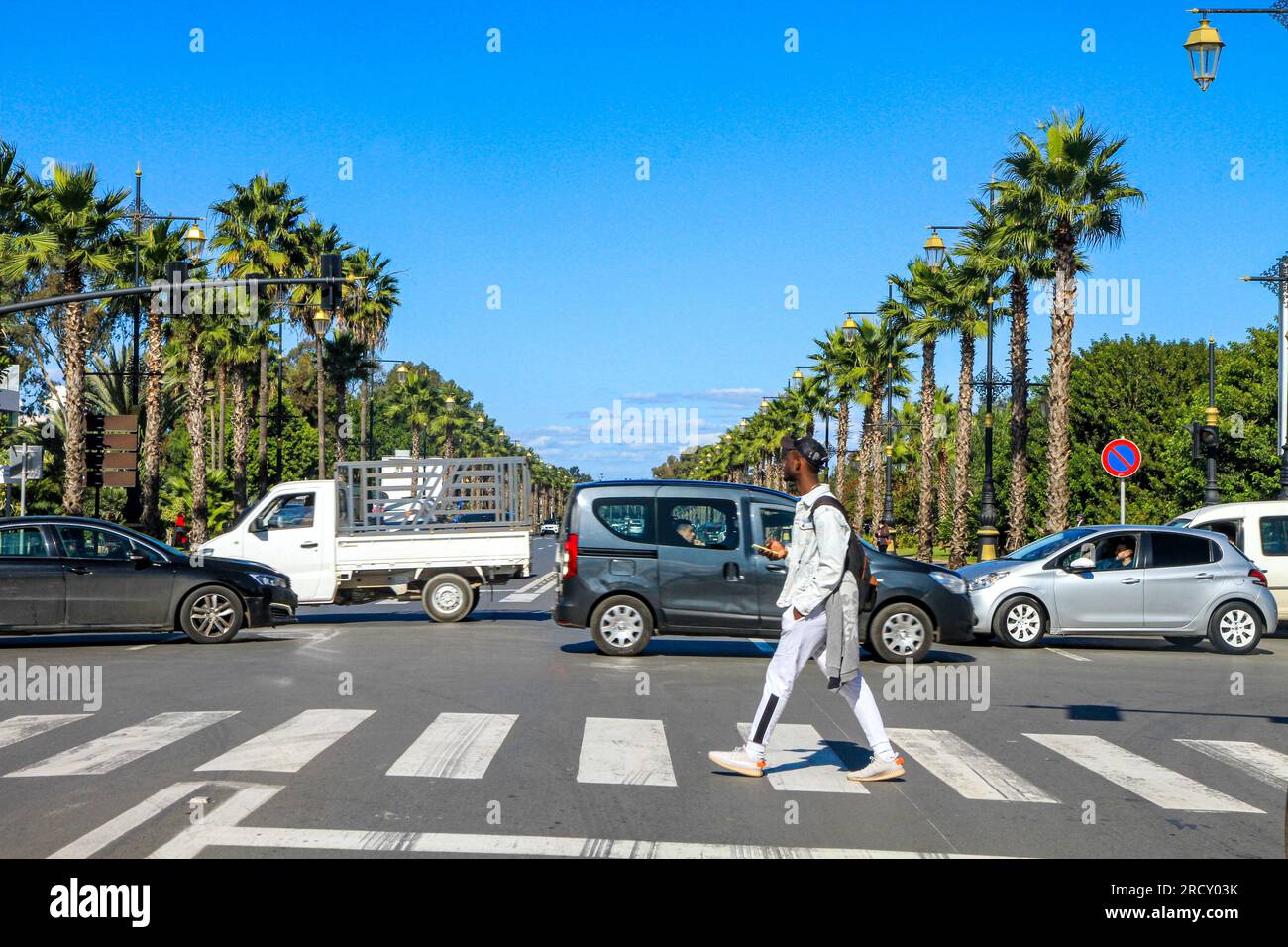 A passerby crosses a pedestrian crossing in a street in Rabat, the ...