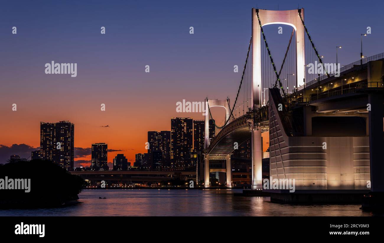 Beautiful sunset colors and city lights of Tokyo and the Rainbow Bridge ...