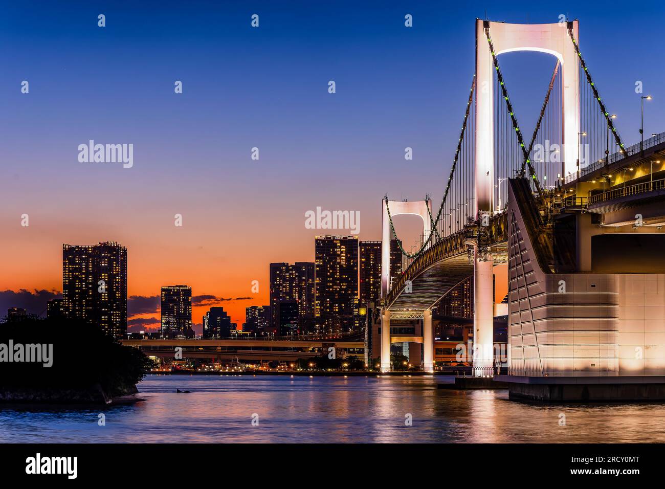 Beautiful sunset colors and city lights of Tokyo and the Rainbow Bridge ...