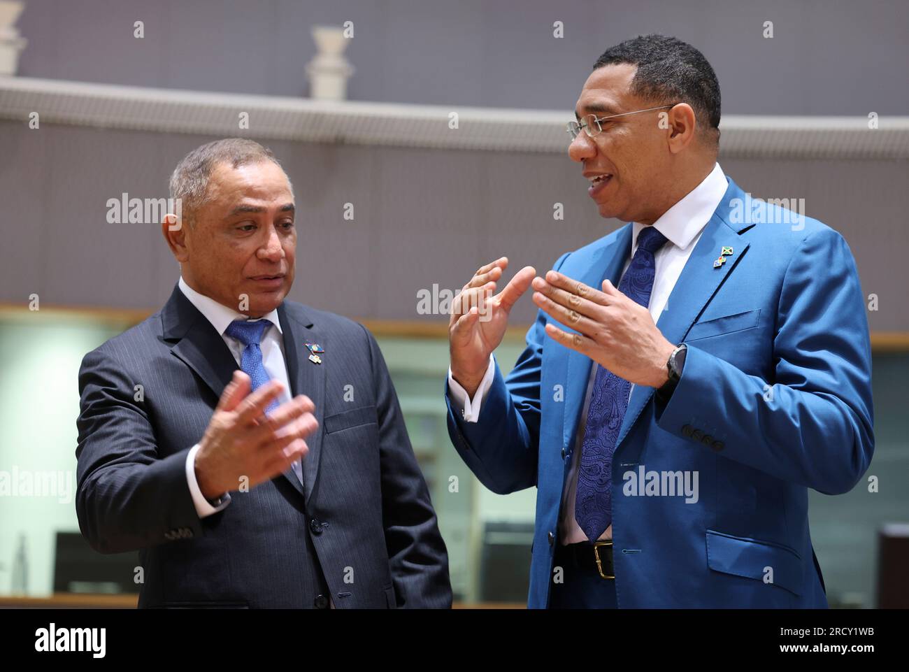 Belize's Prime Minister Johnny Briceno, left, talks with Jamaica's ...