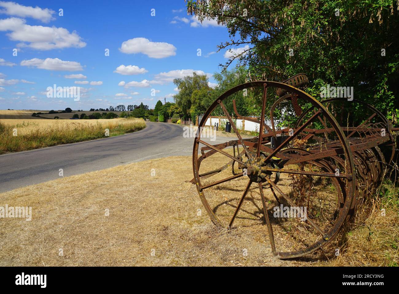 Vintage horse drawn hay turner at the entrance to the village of ...