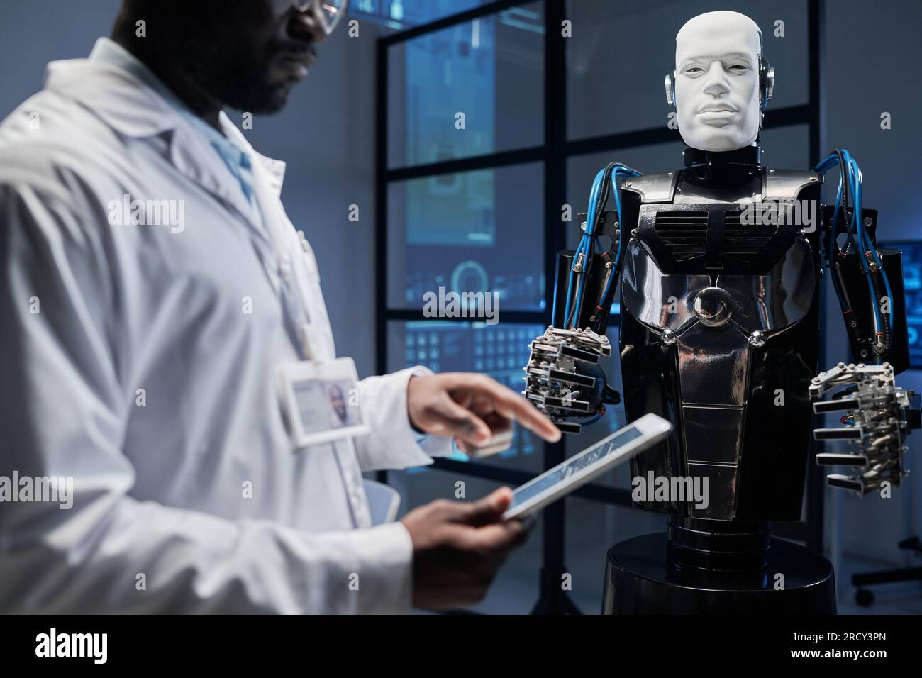 African American engineering in white coat using digital tablet to ...