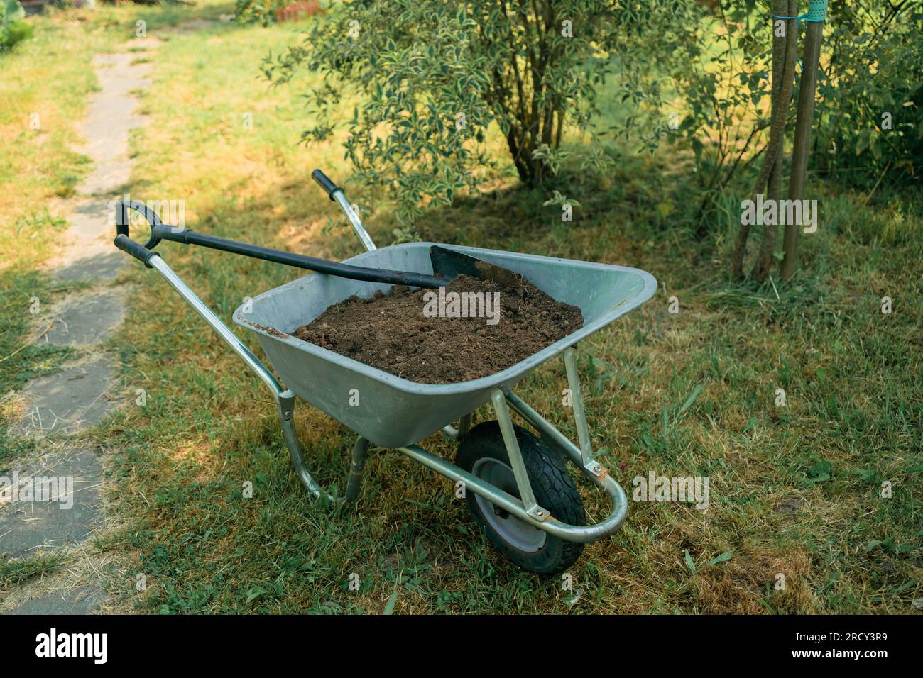 Garden cart with peat on the lawn close-up Stock Photo - Alamy