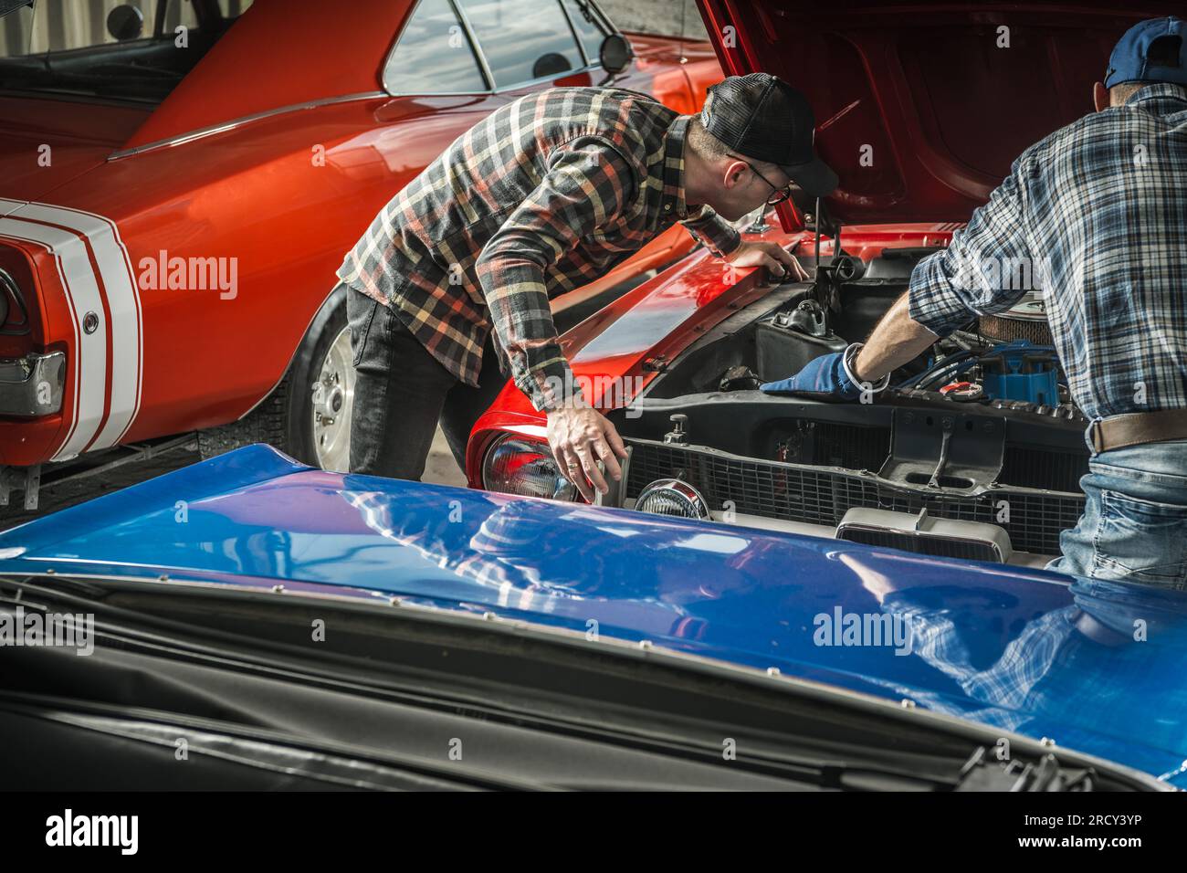 Two Caucasian Professional Classic Cars Mechanics Looking Under Muscle ...