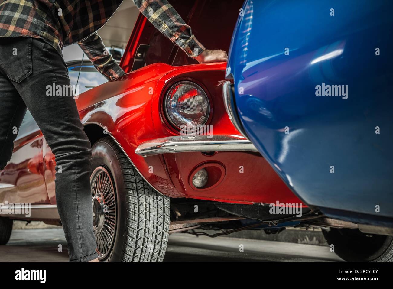 Caucasian Man Looking Under Classic Muscle Car Hood Looking For ... Caucasian Man Looking Under Classic Muscle Car Hood Looking For ...