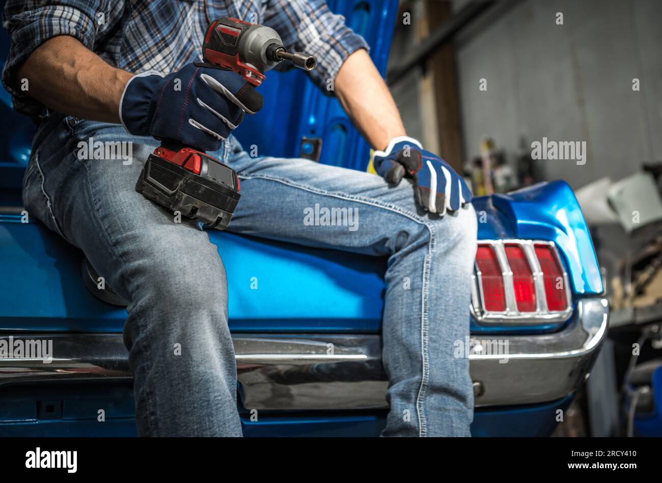 Car Mechanic with Cordless Powertool in His Hand and His Next Muscle ...