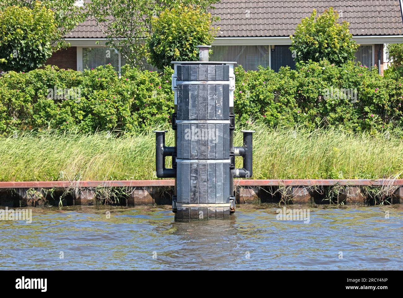 Metal mooring post in a dutch canal Stock Photo - Alamy